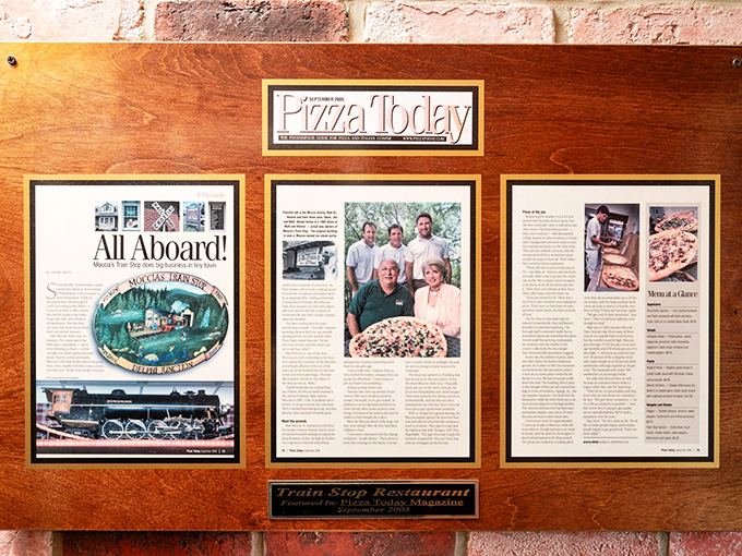 Fame looks good on this wall—framed articles from Pizza Today magazine tell the story of recognition well-earned through years of perfect pies.