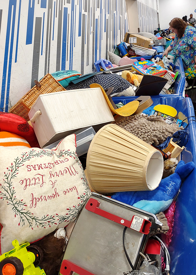 A bin of lampshades, pillows, and possibilities. That "Merry Christmas" pillow in July is the definition of thrift store timing.