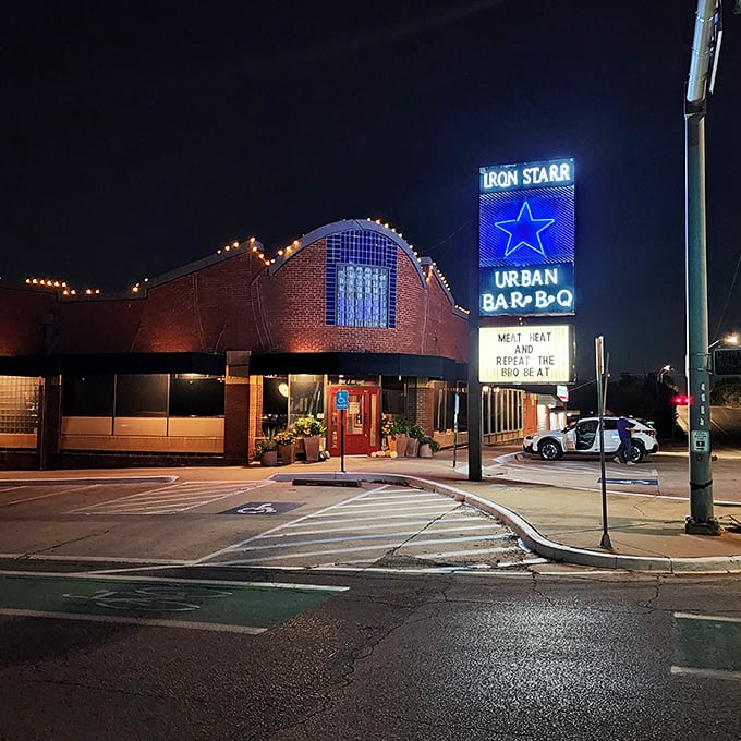As night falls, Iron Star transforms into a glowing landmark—its illuminated sign a North Star for barbecue pilgrims.