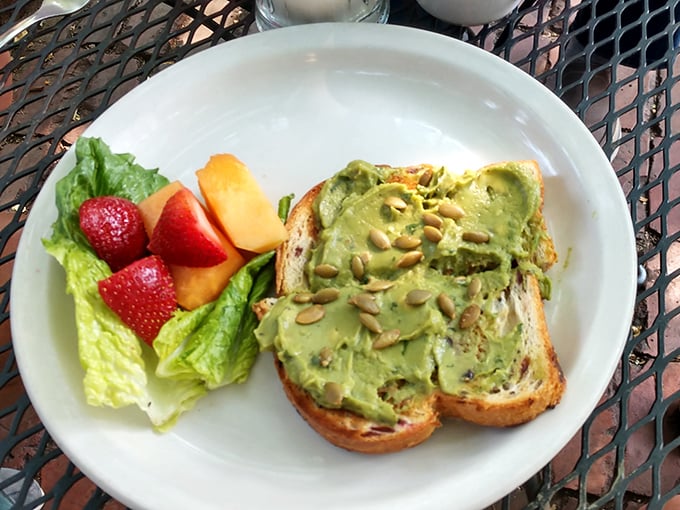 Avocado toast that doesn't require a second mortgage—just perfectly ripe avocado, toasted bread, and a side of fresh fruit that wasn't an afterthought.