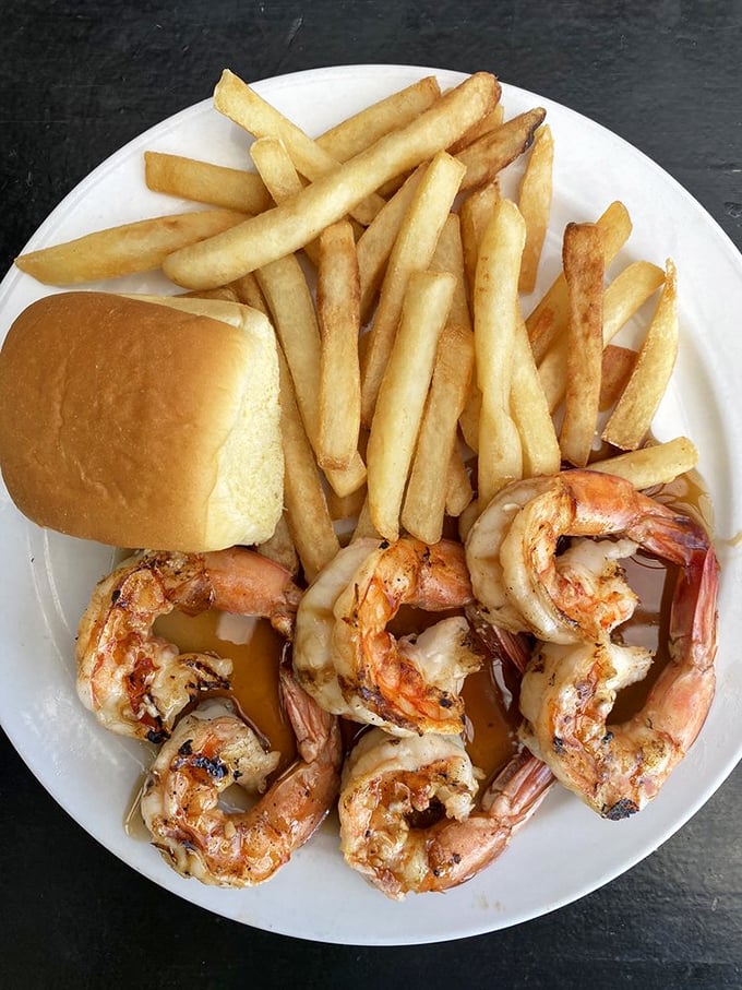 Perfectly grilled shrimp with fries and a roll—simple food done right, proving that sometimes the straightforward approach wins the race.