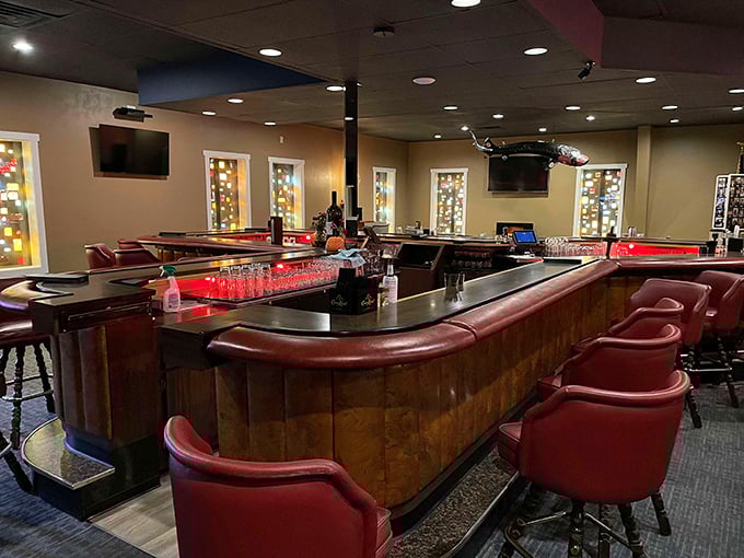 A classic horseshoe bar with plush red seats – where strangers become friends and the perfect Old Fashioned is just a nod away.