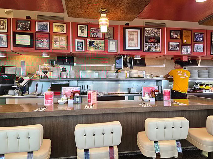 The open kitchen isn't just functional—it's dinner theater where short-order cooks perform culinary choreography that's been perfected over decades.