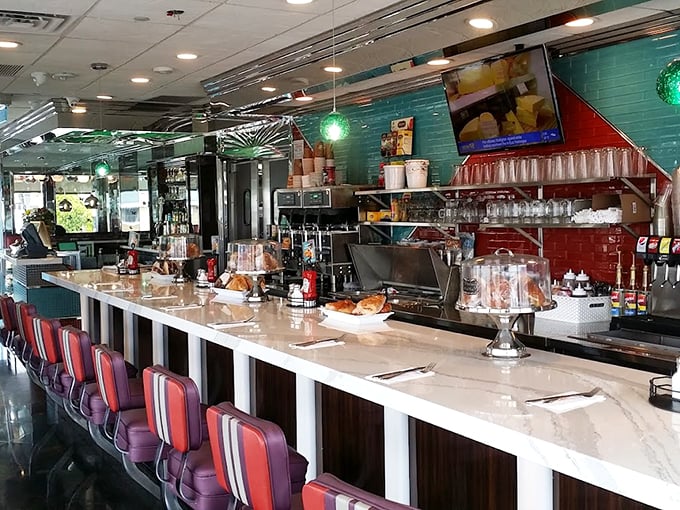 The counter where magic happens—gleaming surfaces, red accents, and the promise of coffee refills as far as the eye can see.
