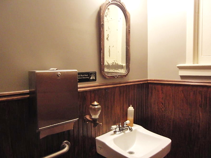 Even the bathroom maintains the vintage charm. No fancy hand dryers here—just classic fixtures that complete the old-school deli experience.