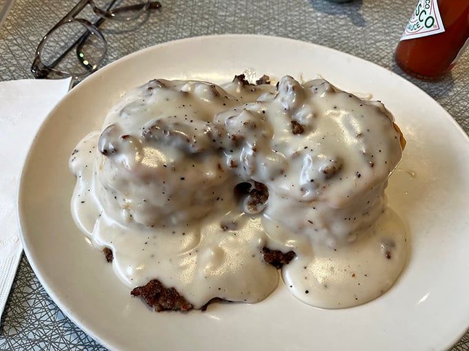 Biscuits and gravy that don't so much sit on the plate as claim territory—a creamy, peppery declaration of Southern breakfast independence.