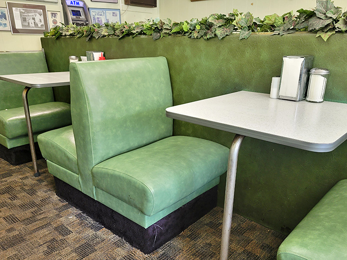 Green vinyl booths provide a splash of retro color, proving that sometimes the best interior design involves comfort and nostalgia.