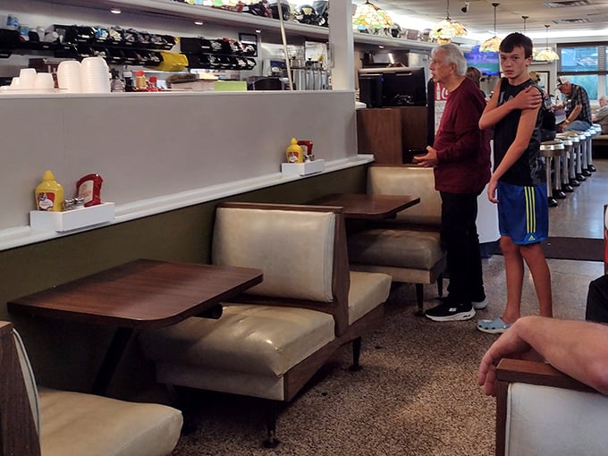 Cozy booth seating offers the perfect perch for people-watching while waiting for your meal – a timeless diner experience.