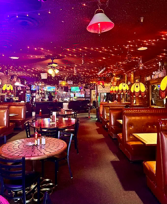 After dark, the dining room transforms into a twinkling wonderland where Tiffany lamps cast their glow over vinyl booths that have cradled Portland's hungry souls for decades.
