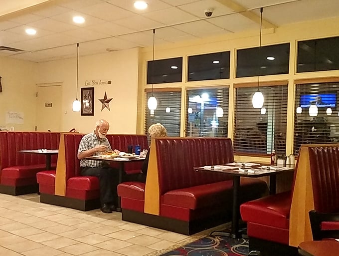 Sometimes an empty booth is the most inviting sight in the world—a canvas awaiting your dining adventure, bathed in gentle pendant lighting.