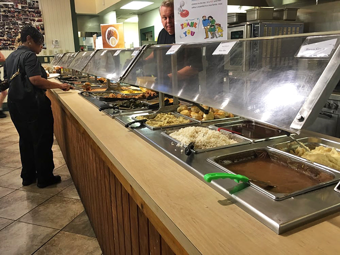 Behind every great Southern meal is a buffet line like this—where steam rises like culinary prayers and every pan holds a different definition of comfort.