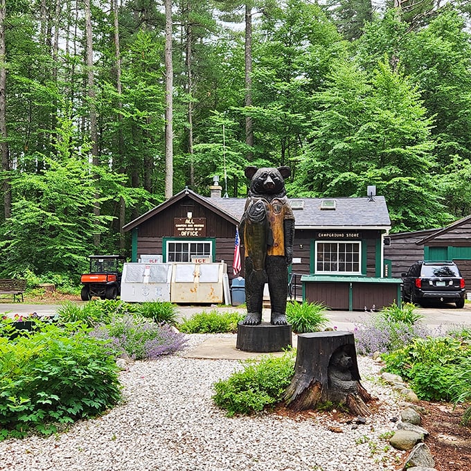 The campground office, guarded by its wooden bear sentinel, serves as civilization's last outpost before you surrender to the wilderness.