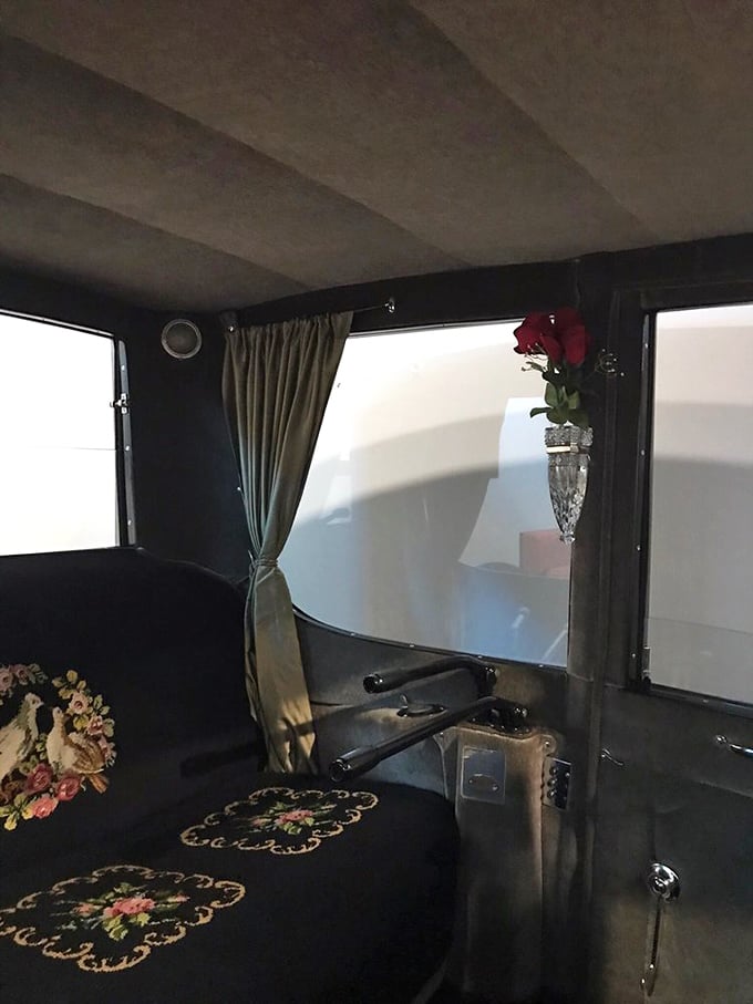 Peek inside luxury from another era – delicate floral embroidery and a crystal bud vase remind us when cars were designed as elegant moving parlors.
