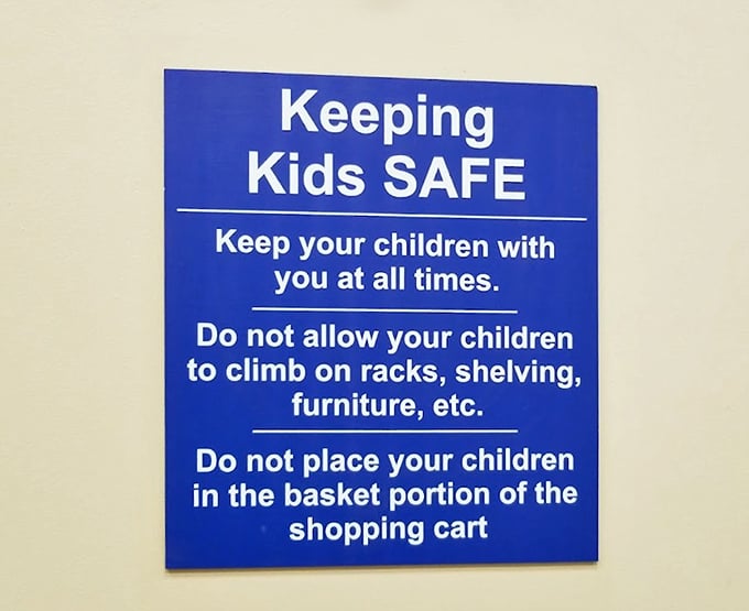 The blue safety sign—a gentle reminder that treasure hunting with toddlers requires extra vigilance. Adventure with caution!