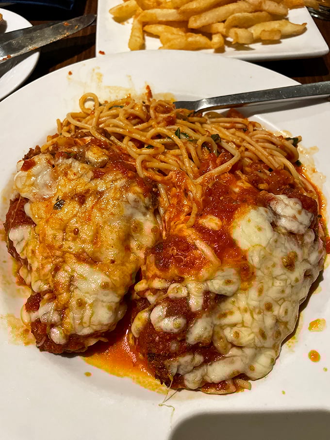 Chicken Parmesan that doesn't know it's supposed to be humble—melted cheese cascading over marinara like it's auditioning for a food magazine.