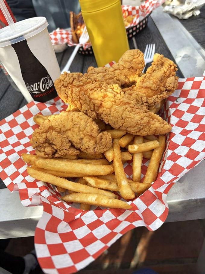 Chicken tenders that actually taste like chicken—crispy, golden-brown coating giving way to juicy meat inside, with fries that could stand alone as a worthy meal.