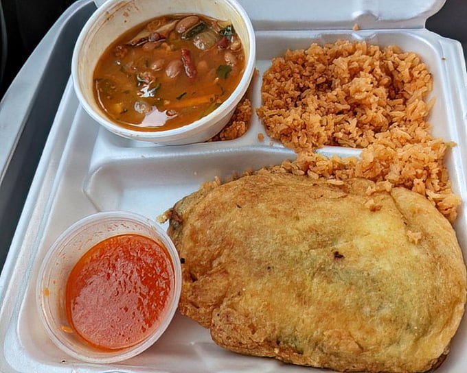 This isn't just lunch – it's a vacation on a styrofoam plate. Rice, beans, and a chile relleno that demands to be the center of attention.