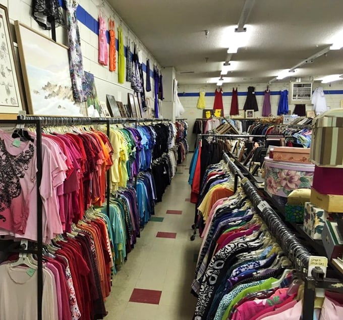 The rainbow road of secondhand fashion, where color-coordinated shirts create a textile spectrum that would make Marie Kondo simultaneously weep and rejoice.