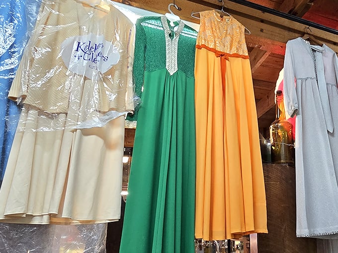 Vintage dresses hang patiently, each one a time capsule from more elegant eras.