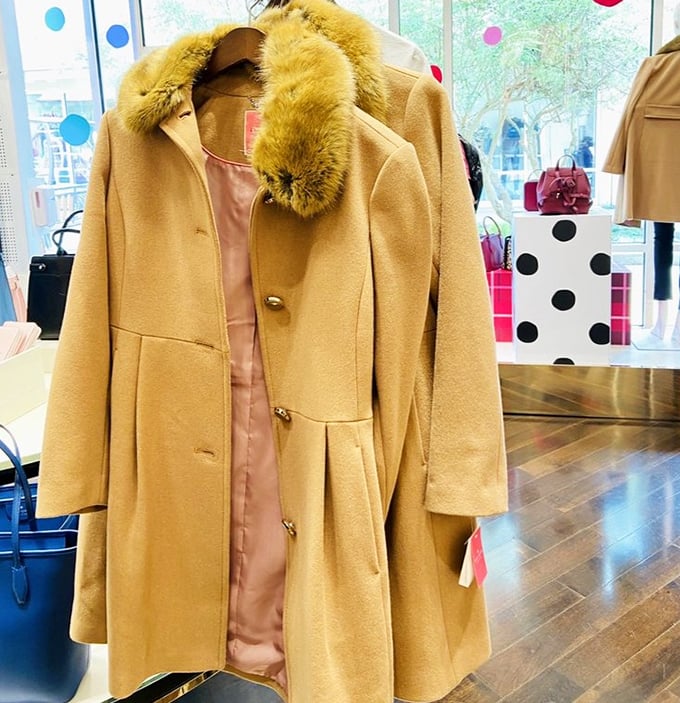 Luxury coats hanging like golden opportunities, whispering sweet savings into your eager ears.