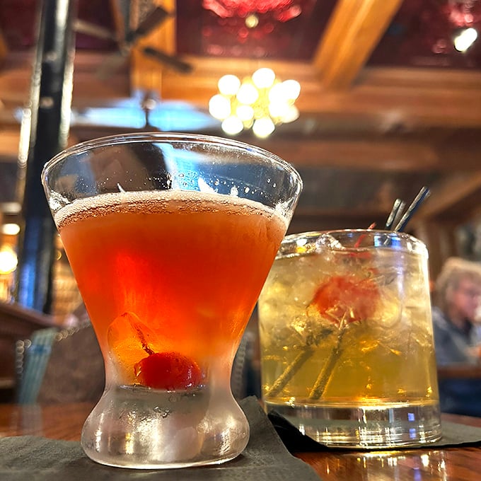 Cocktails that glow with promise under vintage lighting – liquid courage before your steak arrives or liquid celebration after that last perfect bite.
