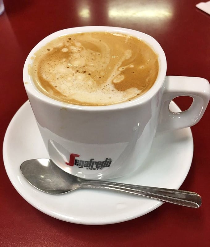 Coffee served in a proper cup with saucer—because some traditions, like afternoon caffeine rituals, deserve their proper respect.