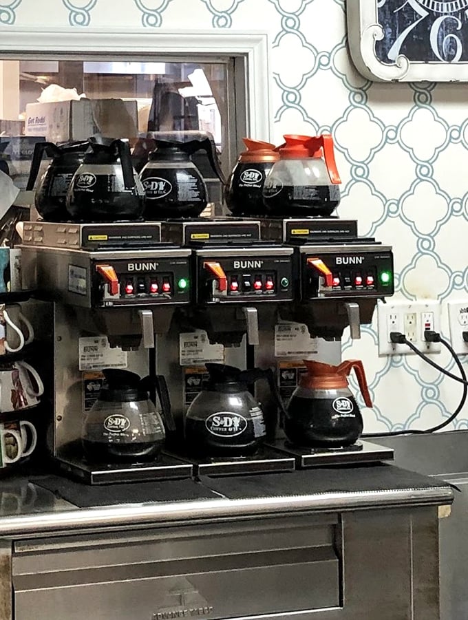 The coffee station—where the magic morning elixir flows freely. Three pots brewing means you'll never face the tragedy of an empty cup.
