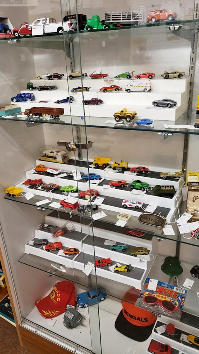 Die-cast dreams behind glass—where middle-aged men suddenly remember the exact Christmas morning they received that tiny fire truck.