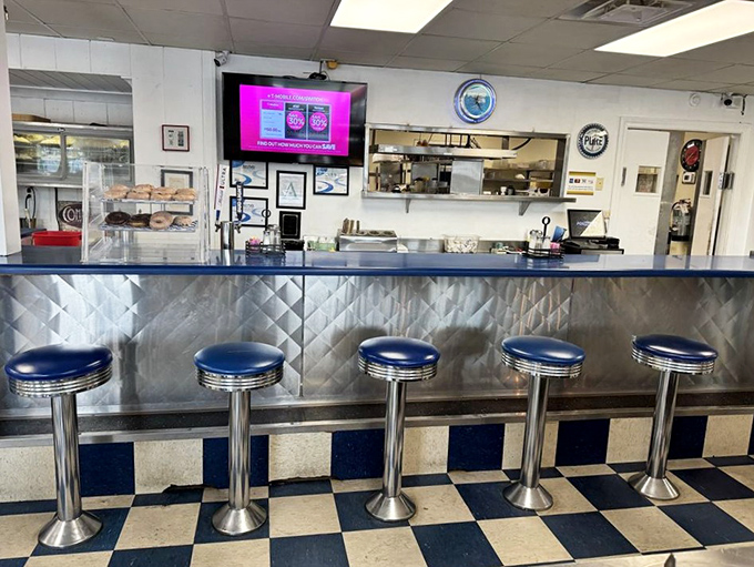 Those blue vinyl stools at the counter have witnessed countless conversations, confessions, and first bites of legendary pie.