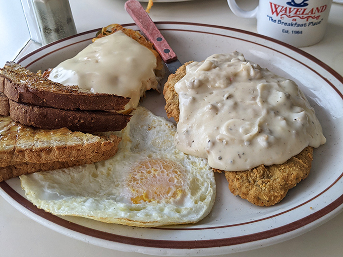 Country fried steak smothered in gravy alongside perfectly cooked eggs and toast. Comfort food that wraps around you like your favorite childhood blanket.