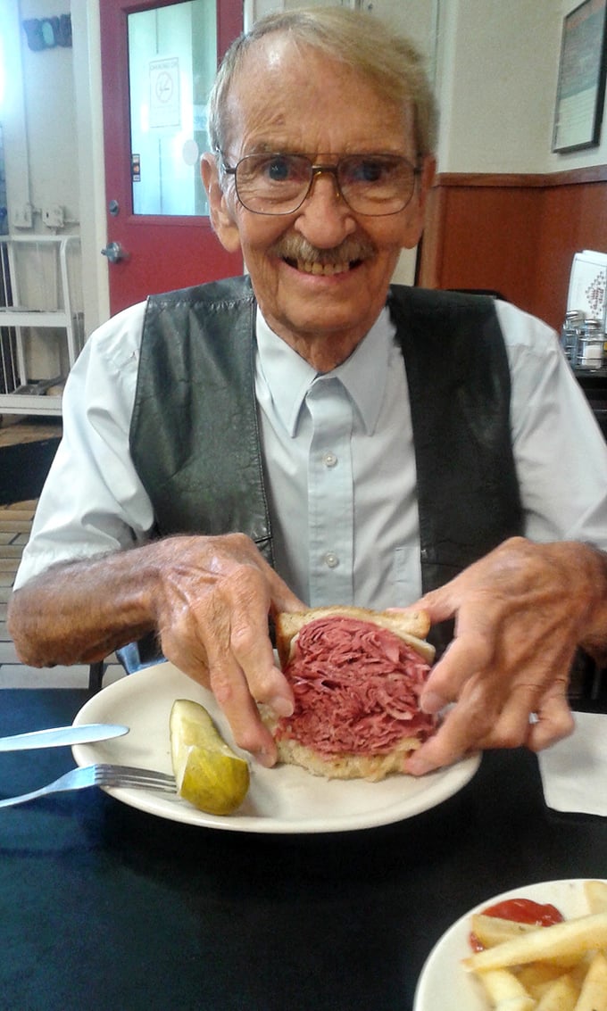The joy of a perfect sandwich captured in one moment. This gentleman knows he's holding Cleveland culinary gold.