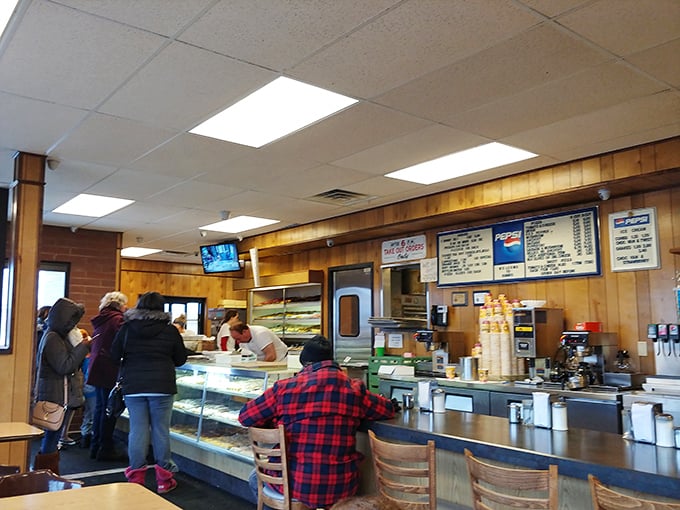 The morning rush at Biagio's—where plaid shirts meet pastry cases and everyone's united by the universal language of "I need a donut right now."