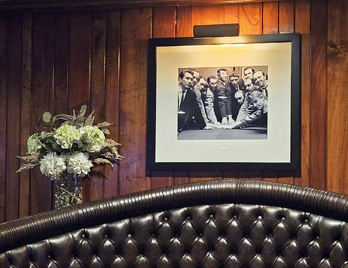 Classic black and white photography adorns the wood-paneled walls, adding a touch of old-school charm to your dining experience.