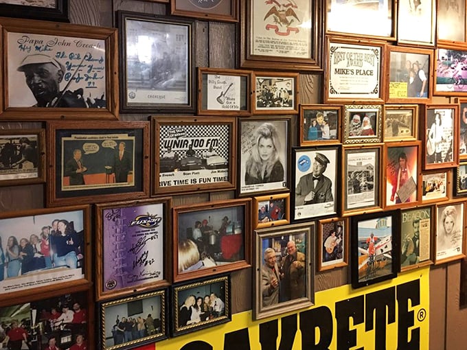 The wall of fame features decades of visitors, celebrities, and memories. Each frame tells a story – some famous, some local, all part of Mike's legacy.