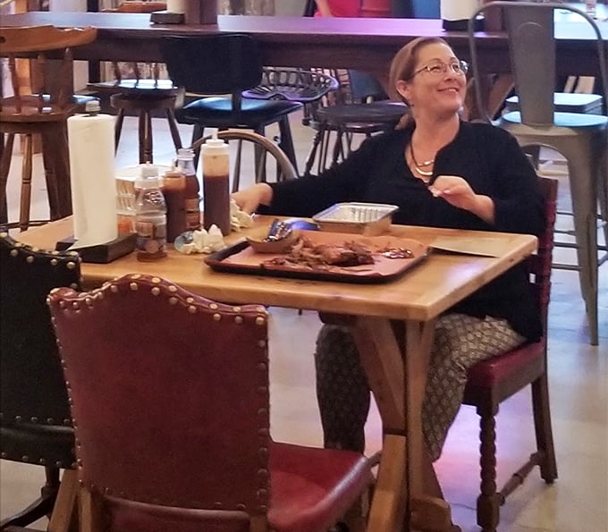 That smile isn't just satisfaction—it's the universal expression of someone who's just discovered Delaware has serious BBQ game worth bragging about.