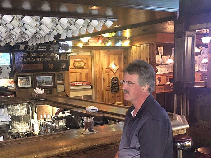 The bar area features hanging mugs and sports memorabilia—where regulars have been solving the world's problems one beer at a time.