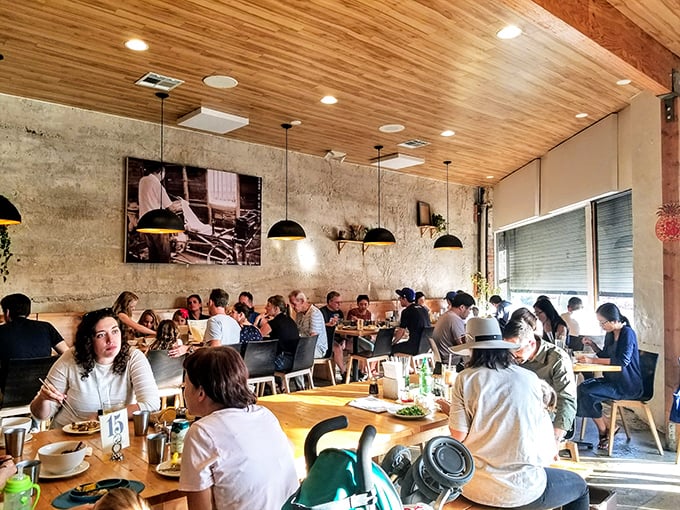 A full house isn't just a sign of popularity—it's validation. Diners lean in over steaming bowls, the universal body language of "you've got to try this."