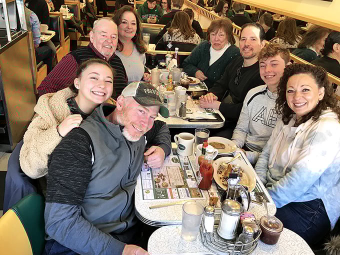 Multi-generational happiness captured in its natural habitat. This isn't just a meal—it's memory-making with a side of maple syrup.
