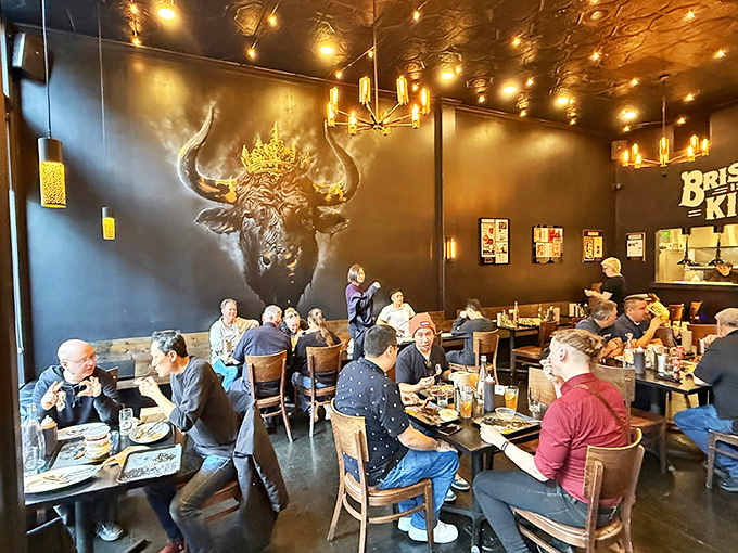 A full house of diners under the watchful gaze of a crowned longhorn—everyone united in the universal language of "mmmmm."