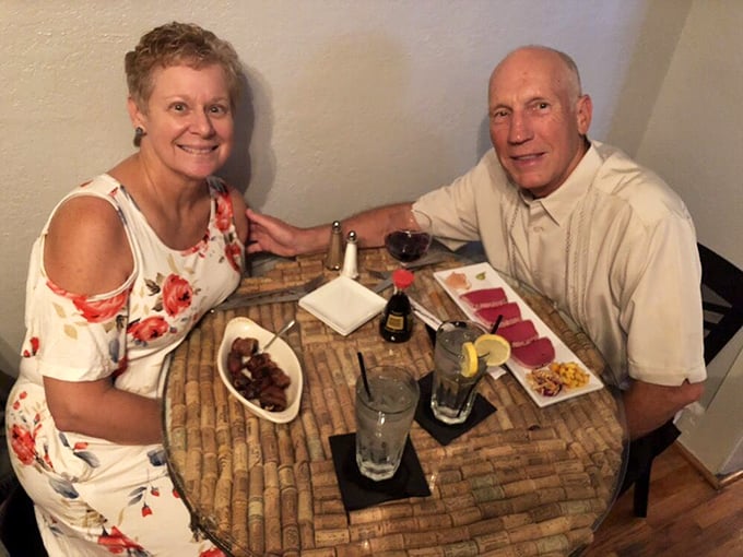 Happy diners enjoying the fruits of Oscar Penn's culinary labor – where every cork-topped table holds the promise of memorable meals.