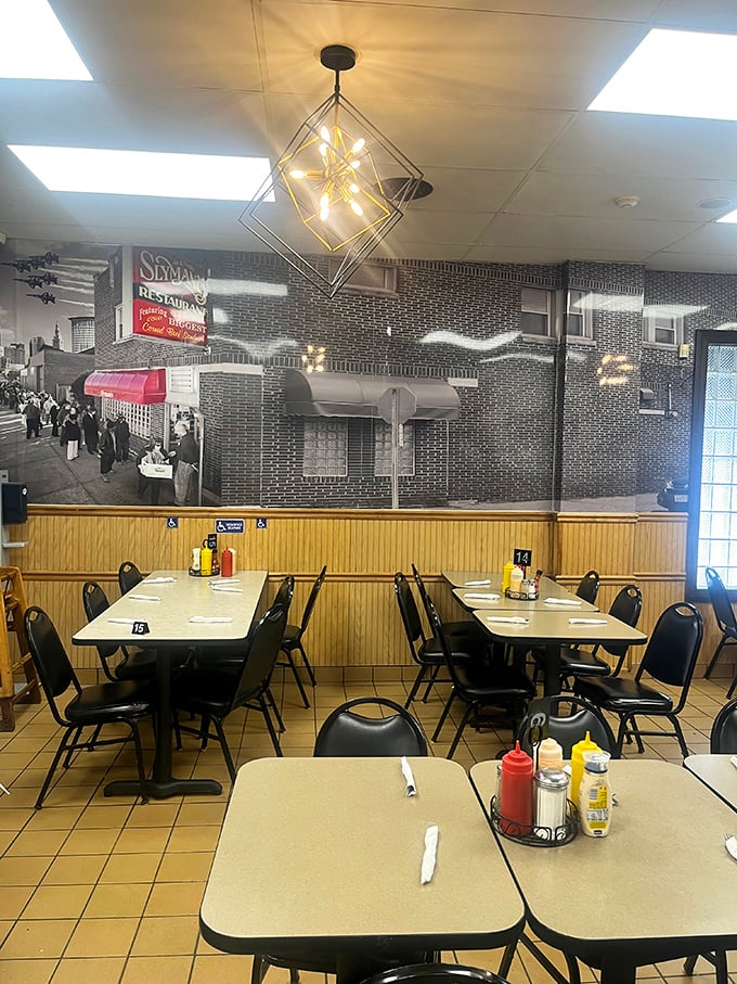 Simple tables beneath historic photos – Slyman's knows ambiance comes from anticipation, not fancy fixtures.