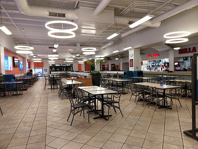 The food court stands eerily quiet before the lunch rush—the calm before the storm of hungry shoppers refueling for round two.