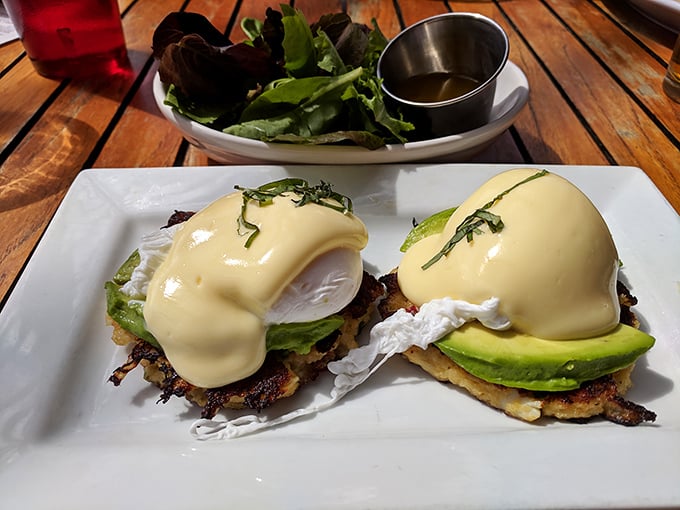 Eggs Benedict gets a coastal makeover with perfectly poached eggs and avocado—breakfast that makes you want to high-five the chef.
