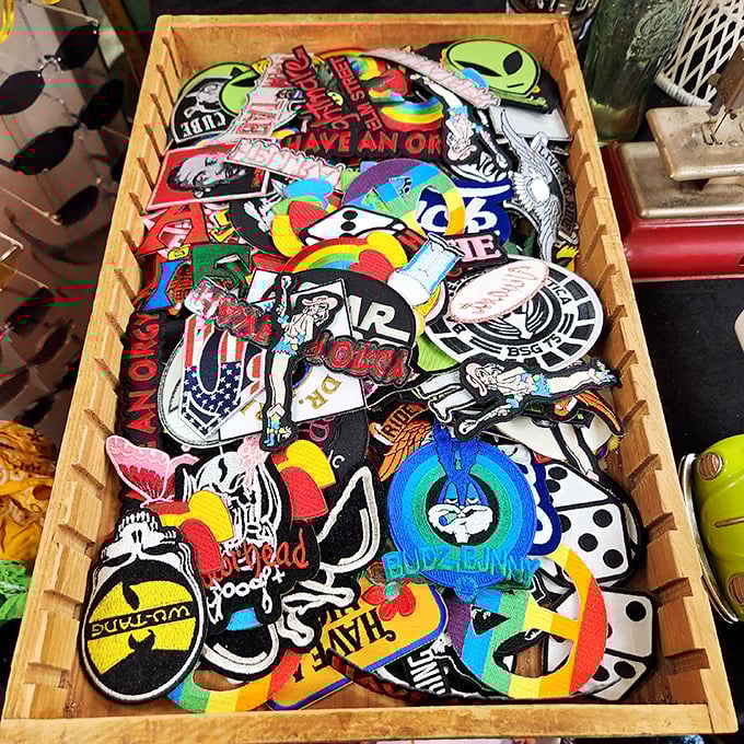 A wooden box bursting with colorful patches—tiny fabric time machines ready to transform your denim jacket into a personal statement.