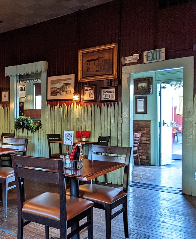 The exit doorway framed by mint-green pickets and decades of history—a portal between everyday life and a timeless dining experience.