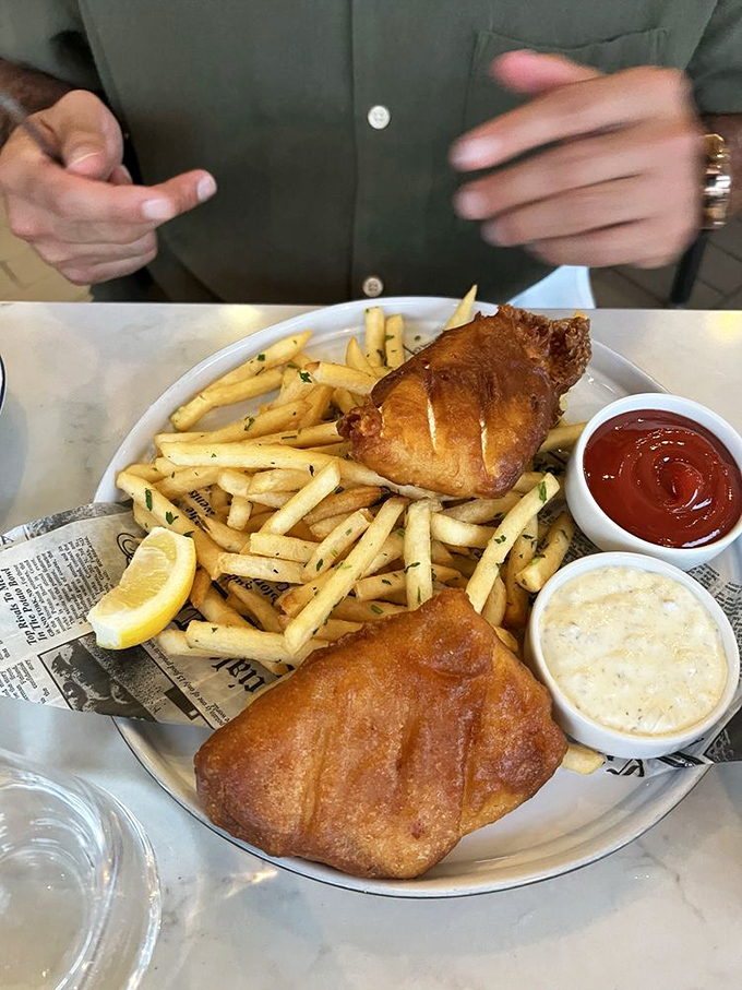 Fish and chips that would make a British pub jealous—golden batter, flaky white fish, and fries that crunch like autumn leaves.