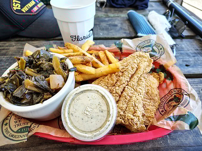 Collard greens, crispy fish, and fries – the holy trinity of Southern comfort that makes you wonder why anyone bothers with fancy food.