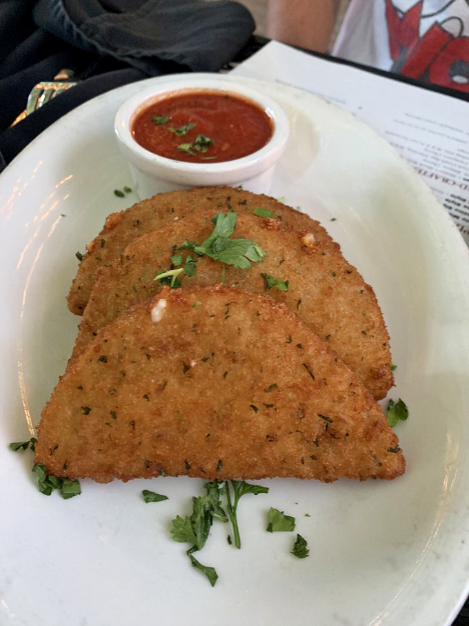 Fried mozzarella that makes a compelling case for simplicity—golden-brown perfection with a side of marinara for dipping or dunking, your choice.