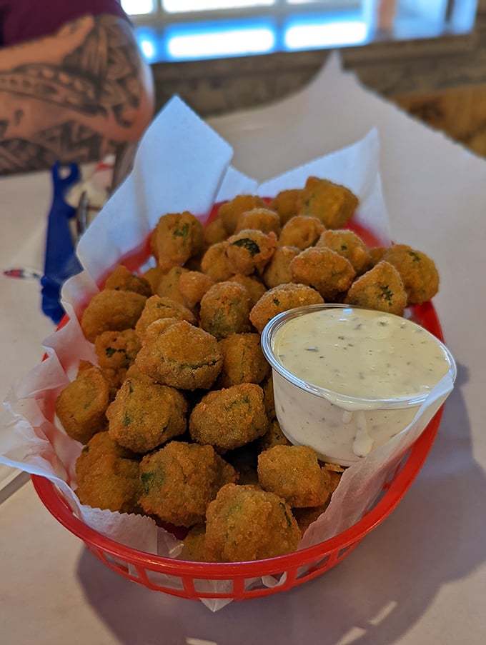 Fried okra that could convert even the most stubborn skeptics—crispy, seasoned bites served with a creamy dip for dunking delight.