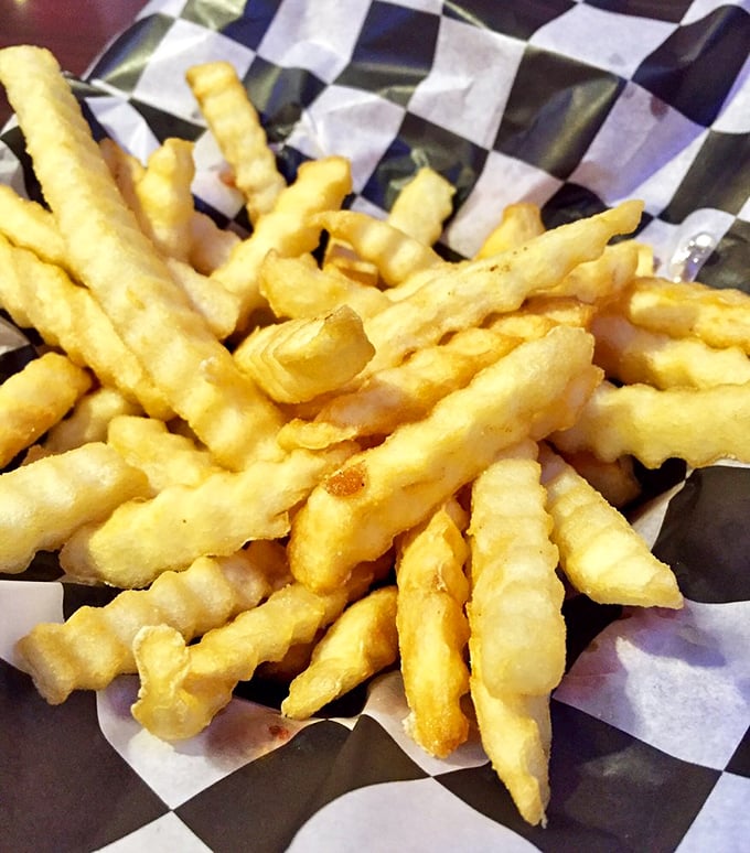 These aren't just french fries—they're golden happiness sticks, perfectly crisp on the outside, fluffy within, and absolutely worth the extra lap around the lake tomorrow.